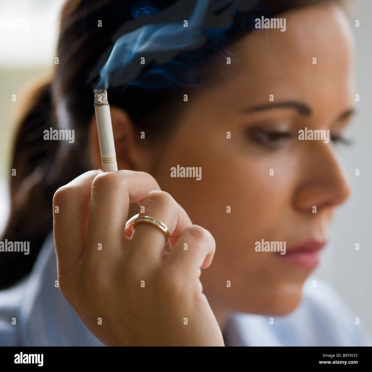 Smoking woman with a cigarette Stock Photo - Alamy