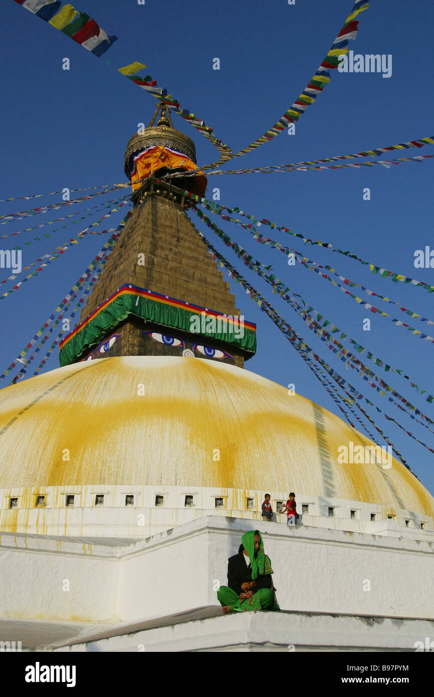 A local Nepali woman sits on the Boudhanath Stupa in Kathmandu, Nepal ...