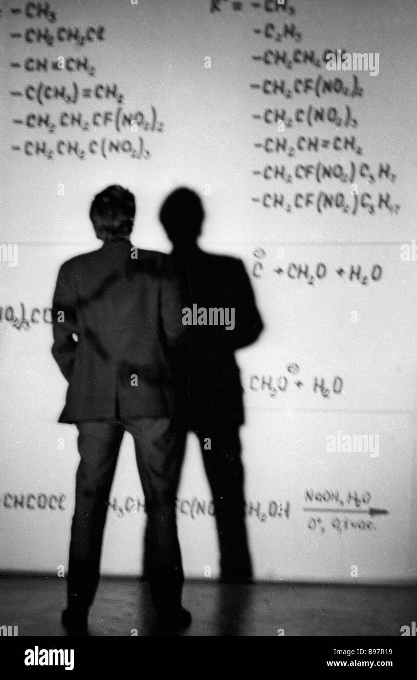 A researcher examining the diagram of a complex chemical process Stock ...