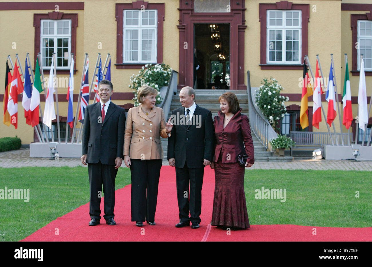 German Chancellor Angela Merkel and her husband Joachim Sauer left and ...