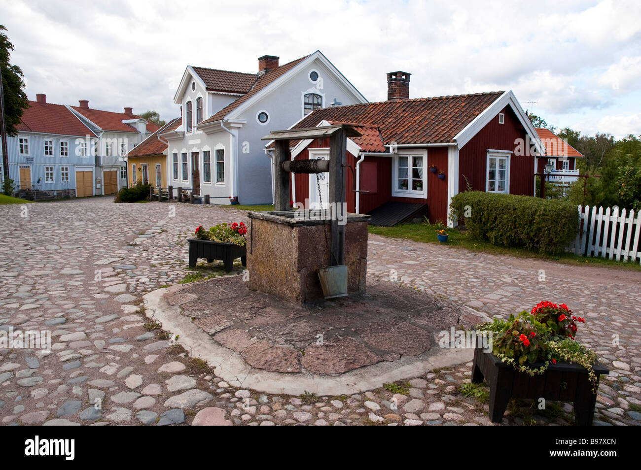 Quaint Swedish village with well and cobblestone streets Stock Photo ...