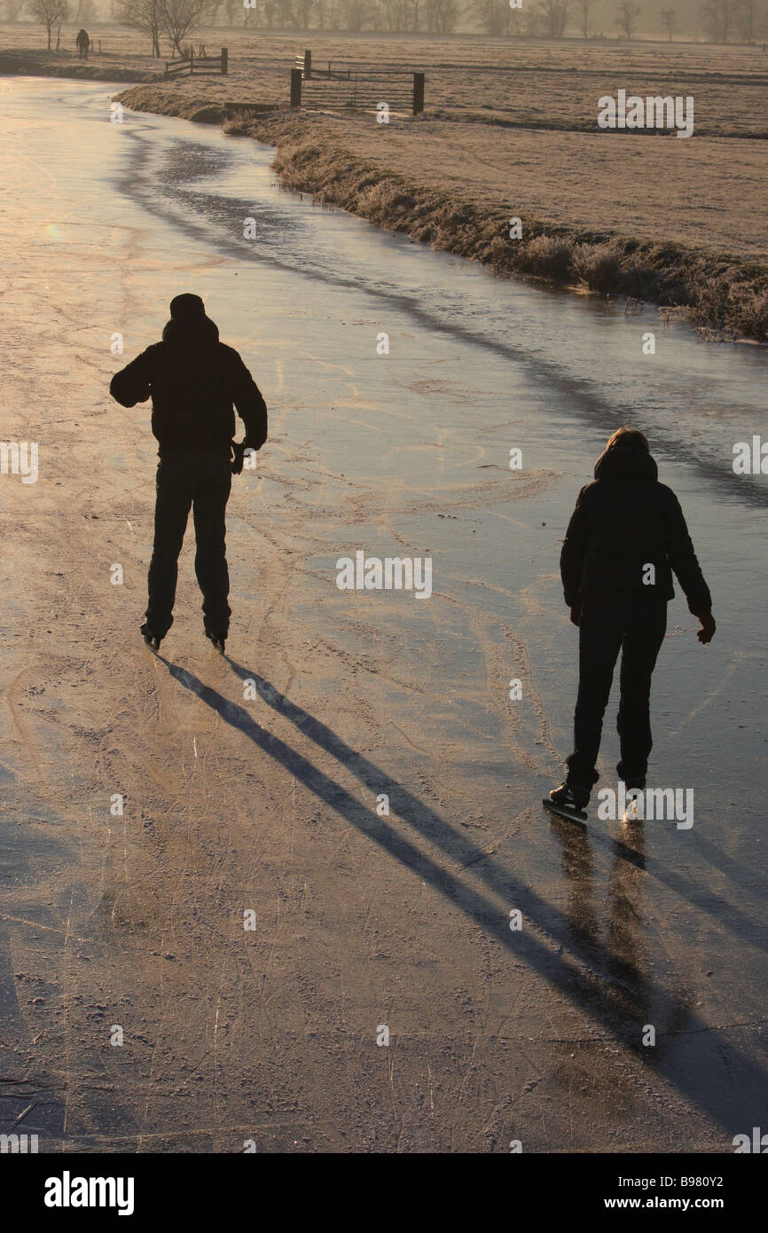 Two iceskaters on a wintersday Stock Photo - Alamy