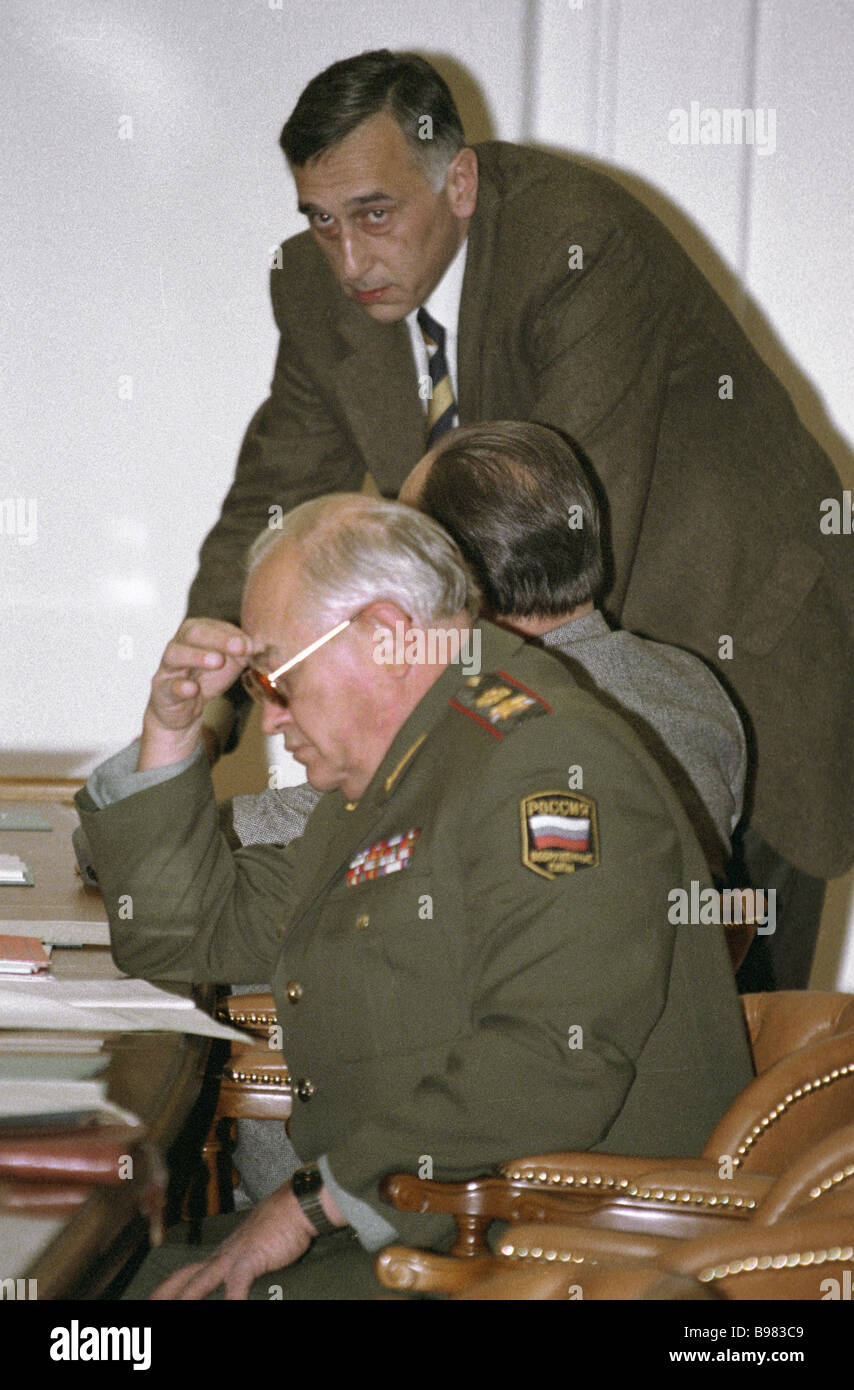 Russian Defense Minister Igor Sergeyev sitting and Trade Minister ...