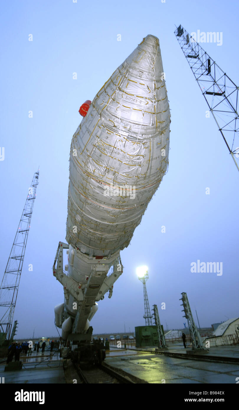 A Proton M launch vehicle with a Kosmos spacecraft at a launch facility ...