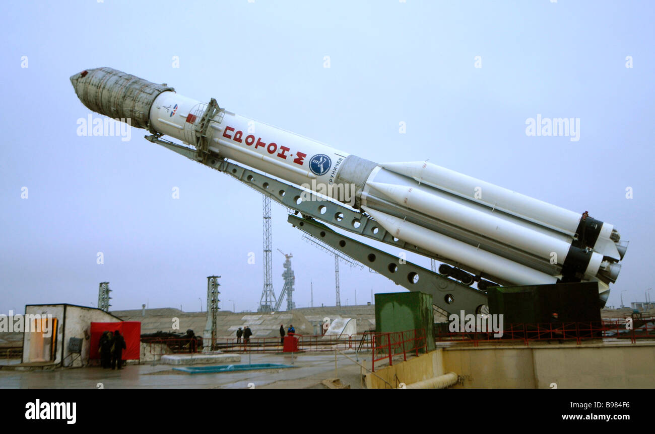 A Proton M launch vehicle with a Kosmos spacecraft at a launch facility ...