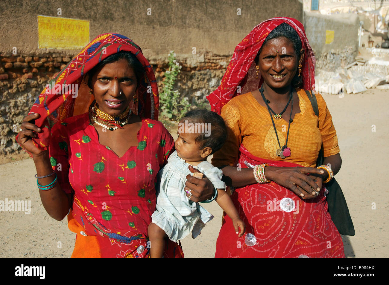Two Rajasthani women with child Bright red clothing Shekhawati region ...