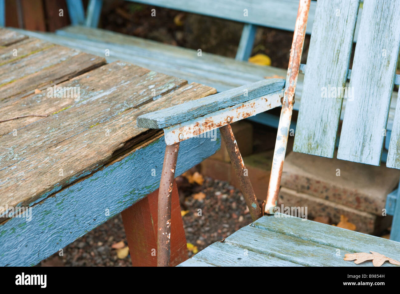 Dilapidated chair and table, close-up Stock Photo - Alamy