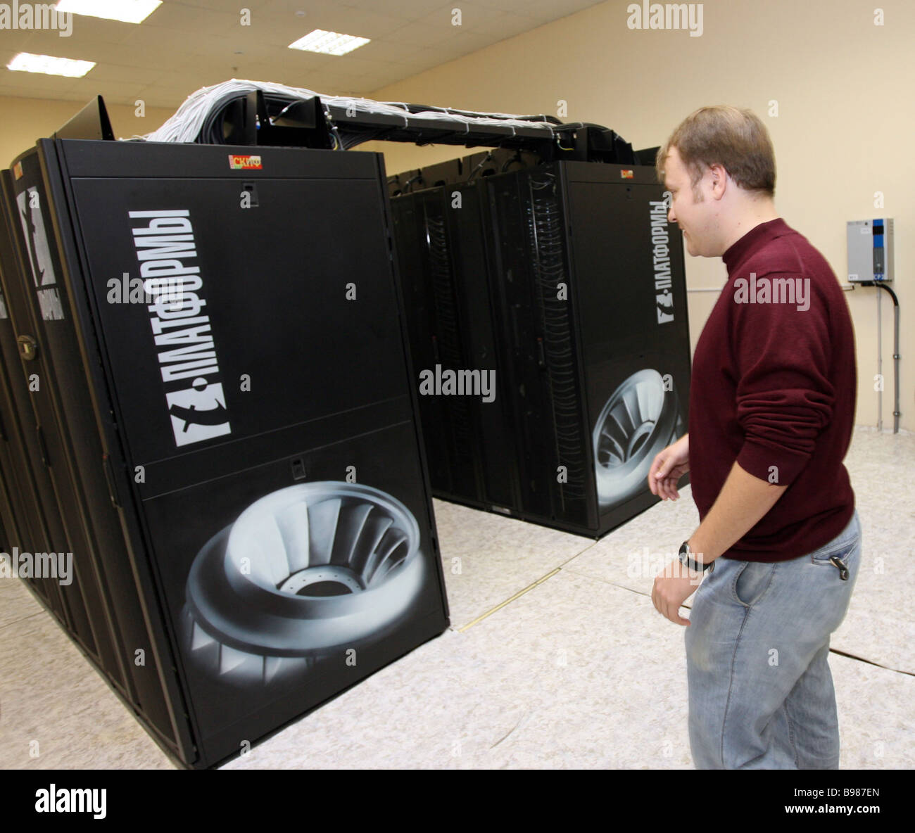An engineer shows the supercomputer SKIF CYBERIA at the Tomsk State ...