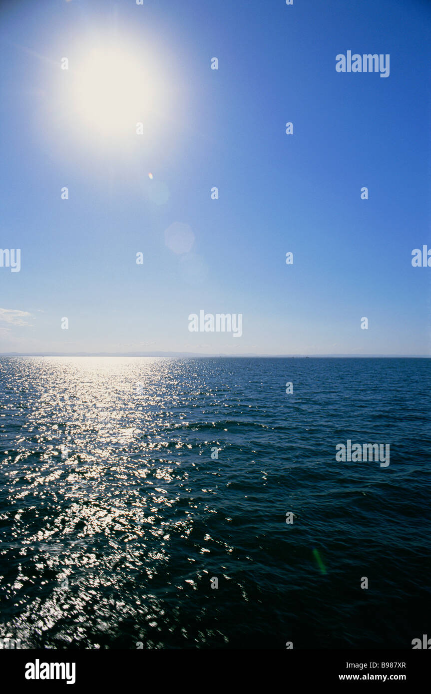 Sun over ocean Stock Photo - Alamy