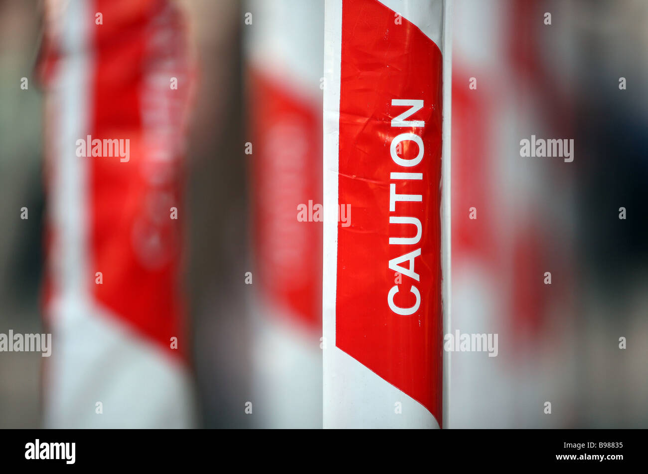 Plastic caution wrapping on scaffolding poles Stock Photo - Alamy
