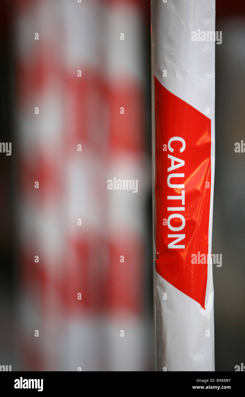 Plastic caution wrapping on scaffolding poles Stock Photo - Alamy