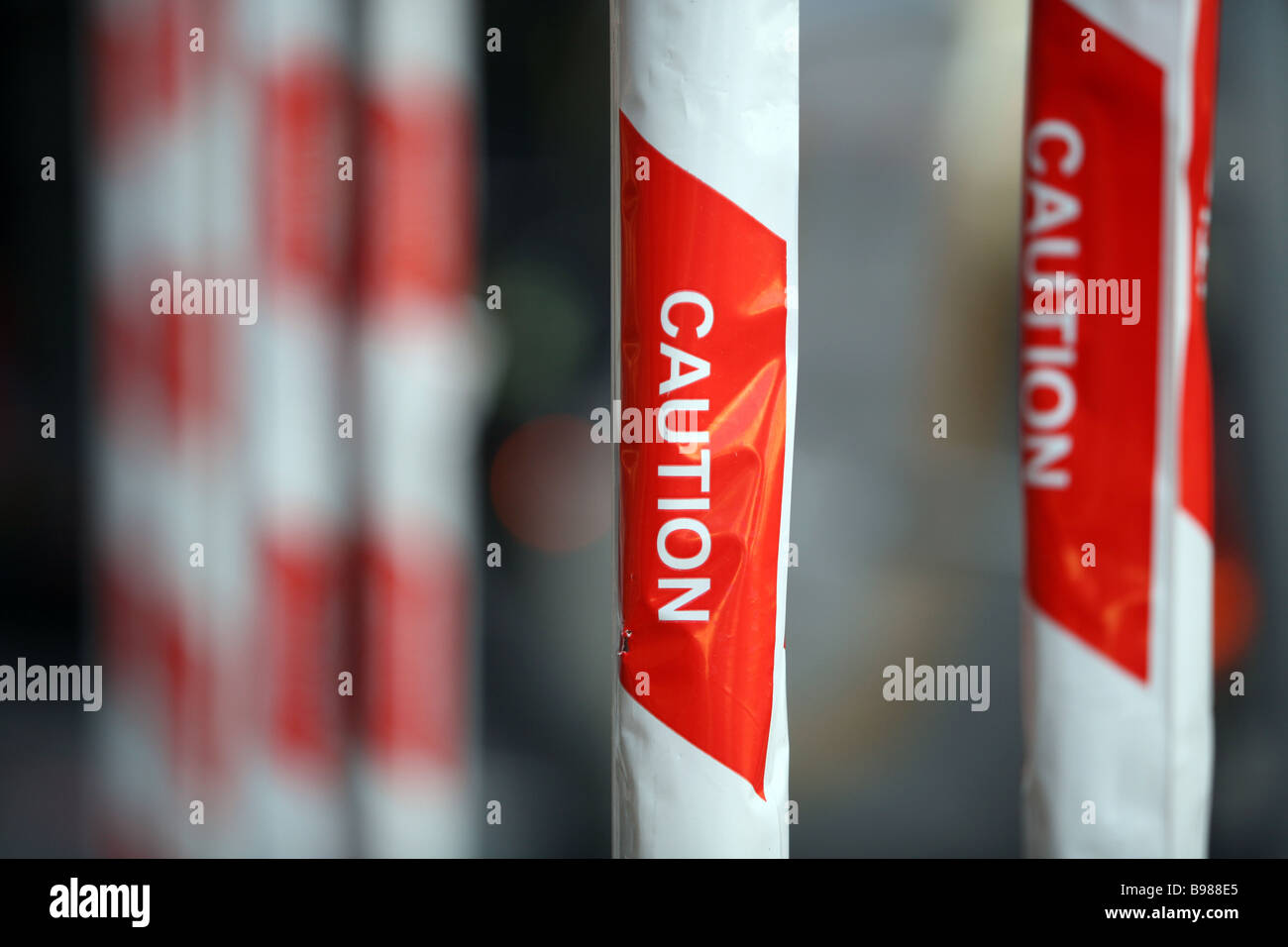 Plastic caution wrapping on scaffolding poles Stock Photo - Alamy