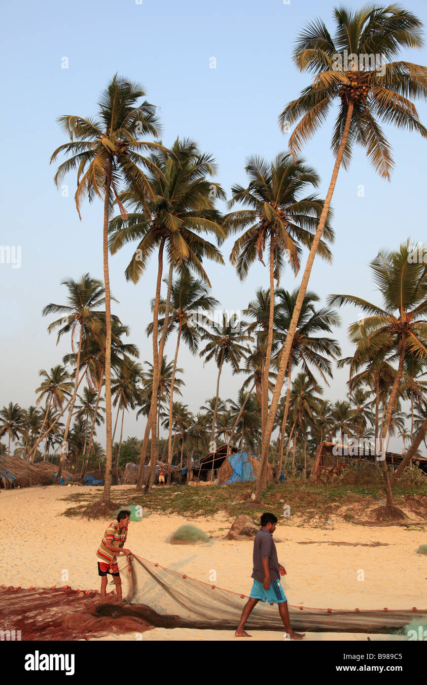 India Goa Colva beach fishermen with fishing net palms scenery Stock ...