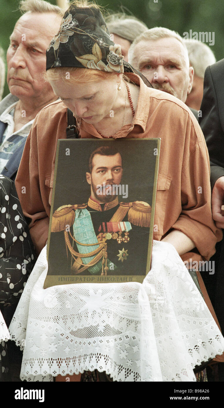 Woman with the portrait of Nicholas II participates in the funeral ...