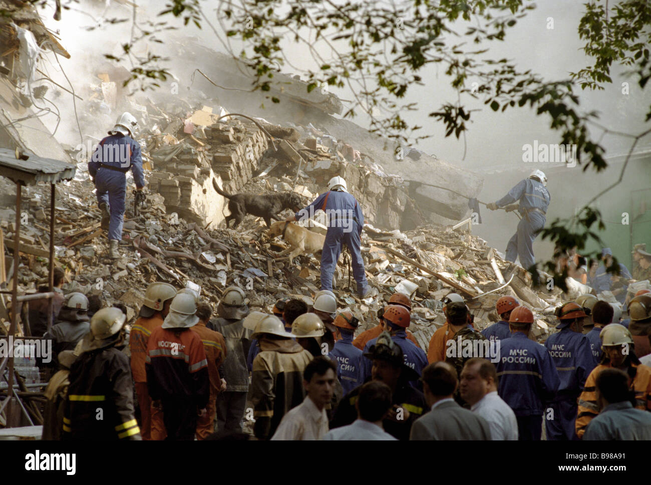 Rescuers cleaning up the rubble after a home gas explosion in one of ...