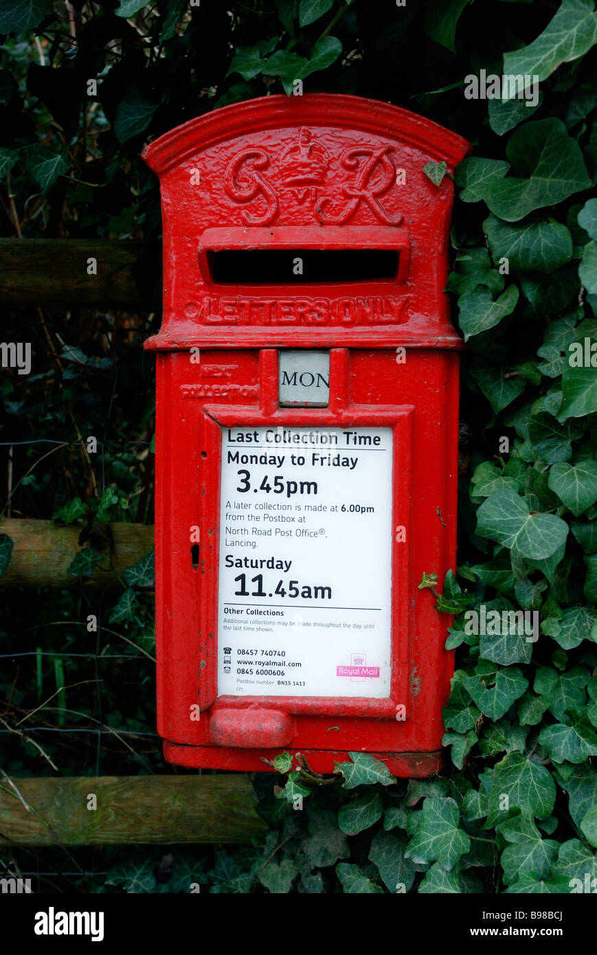 A rural post box surrounded by Ivy in Lancing Stock Photo - Alamy