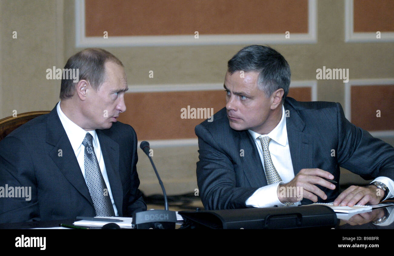 Russian President Vladimir Putin left and his aide Alexander Abramov ...