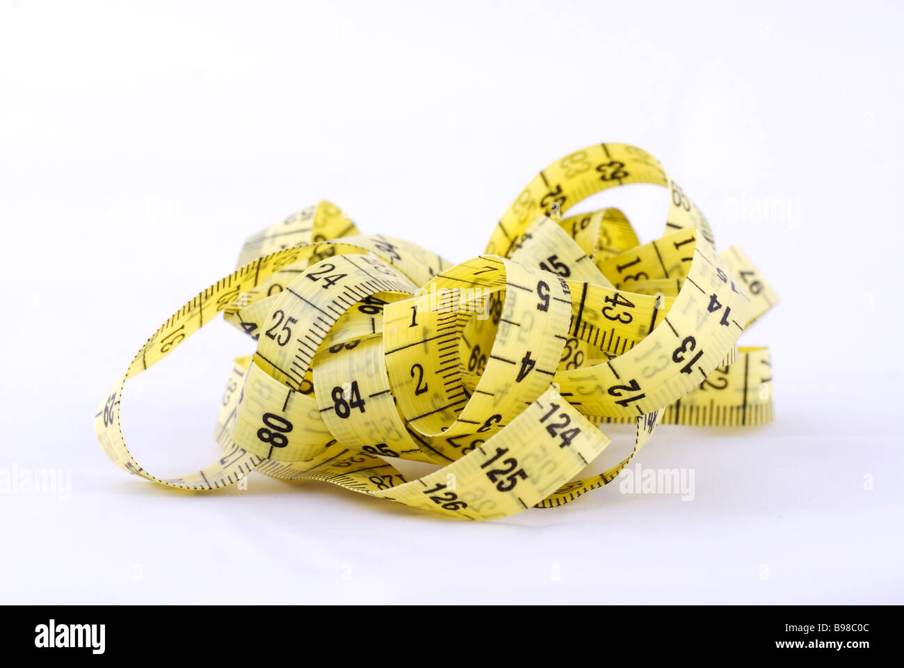 Tangled tape measure isolated against a white background Stock Photo ...