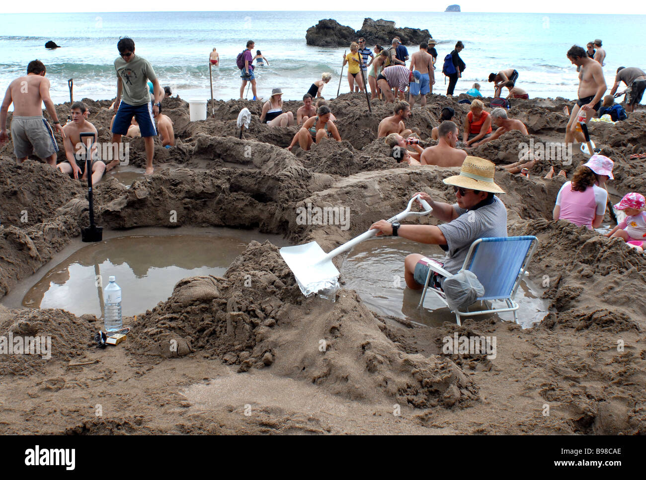 Digging in on Hot Water Beach Hahei Coromandal New Zealand Stock Photo ...
