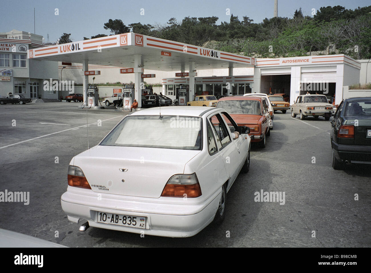 Cars approaching a petrol station Stock Photo - Alamy