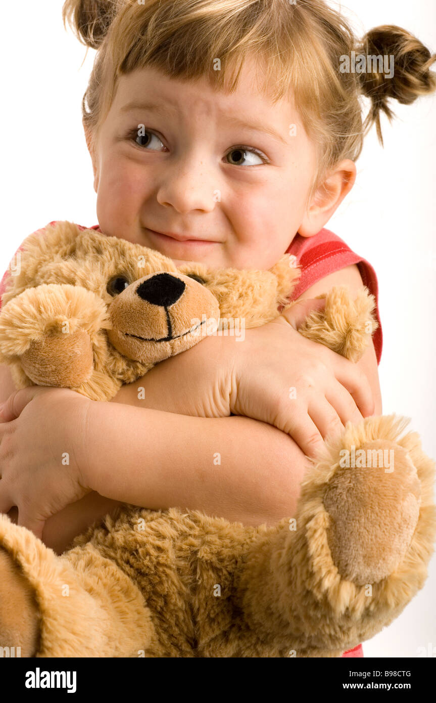 Little girl hugging a teddy bear,white background Stock Photo - Alamy