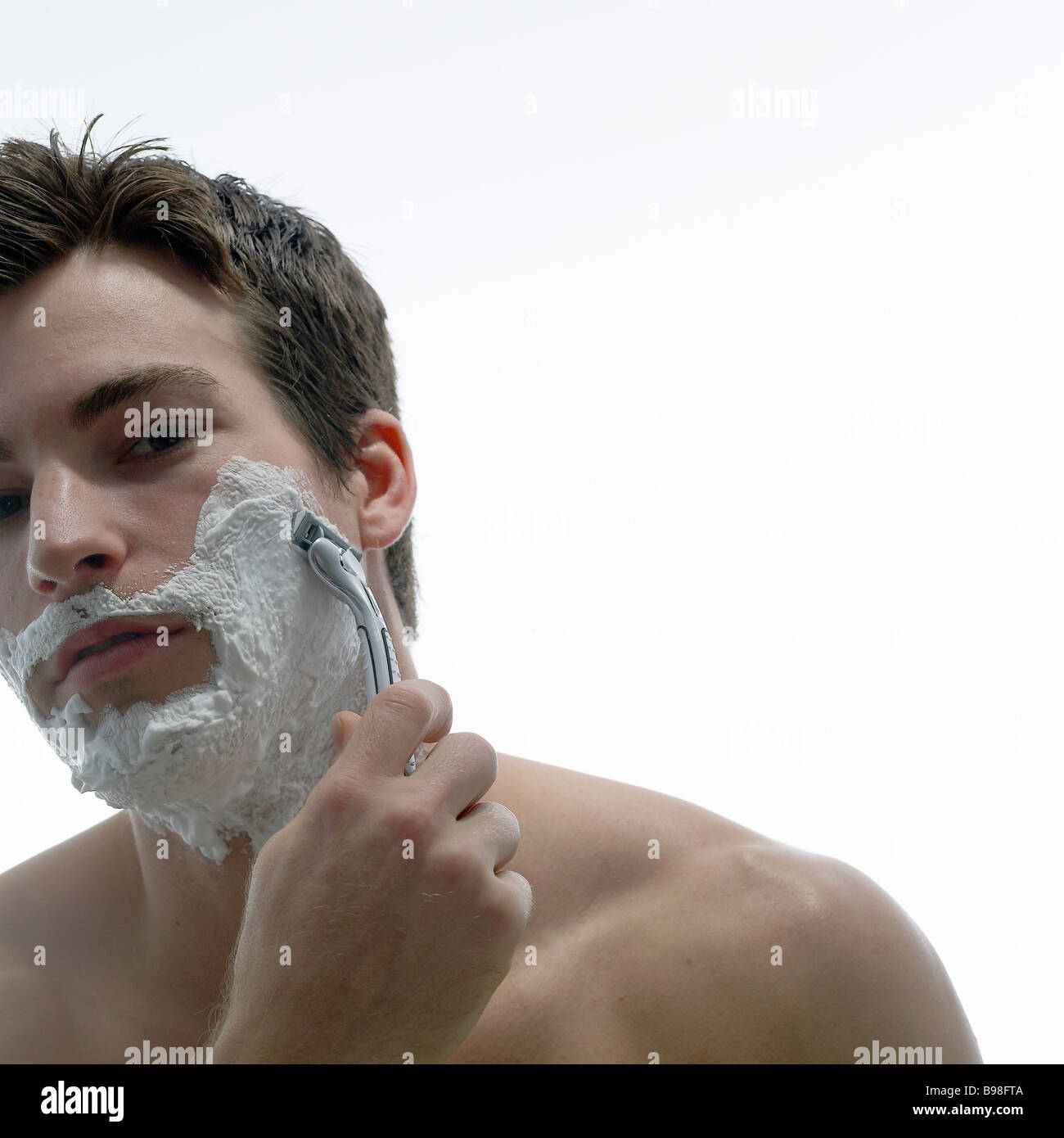 Man shaving face with shaving foam Stock Photo - Alamy