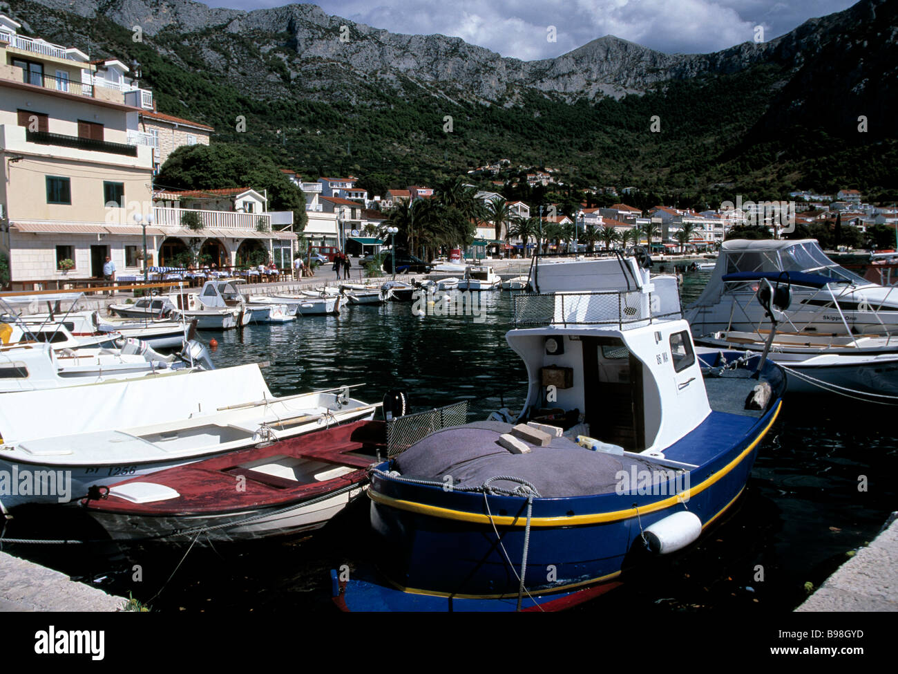 natural sea inlet with a number of small boats tied up at quay walls in ...