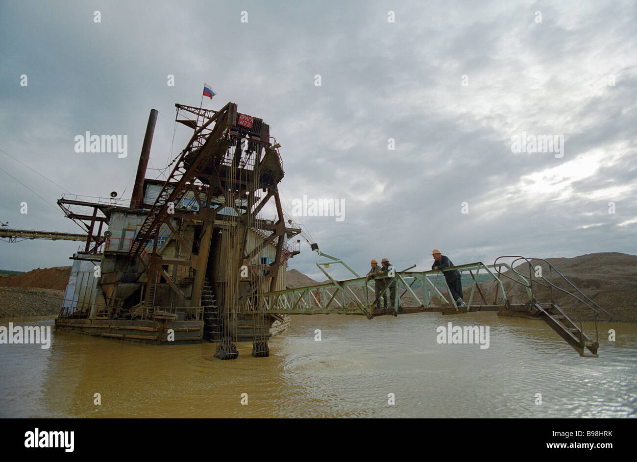 A gold mining dredge at the shore based dressing mill of the ZAO ...