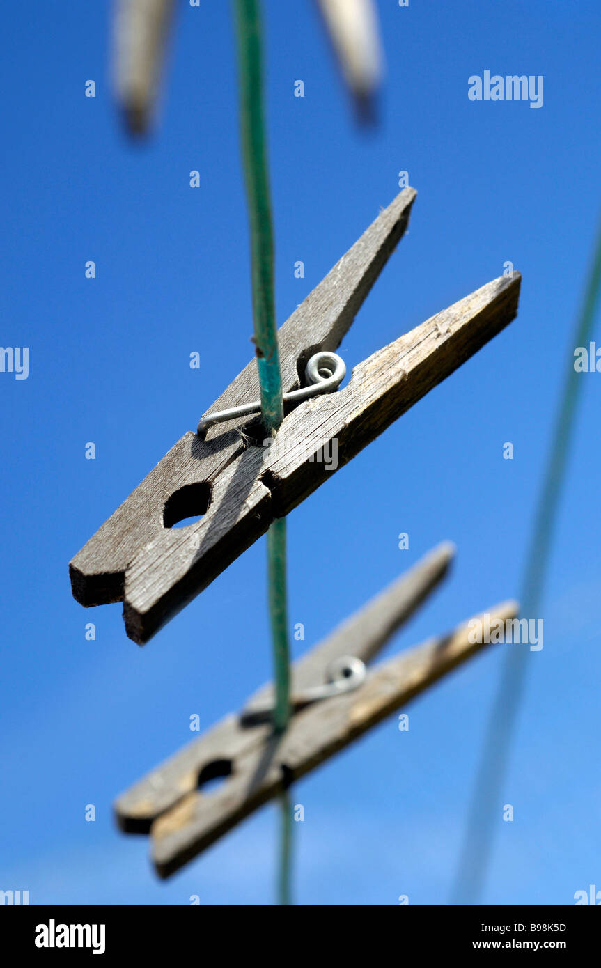 wooden clothes pegs on a washing line against a blue sky Stock Photo ...