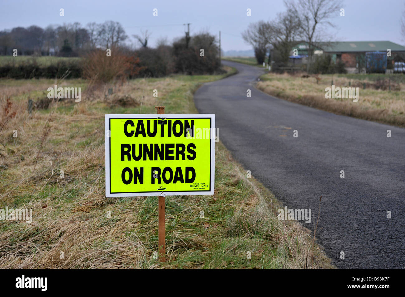 sign informing of possible runners on road Stock Photo - Alamy