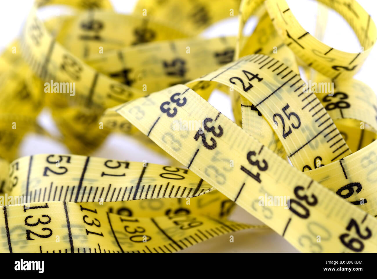 Tangled tape measure close up Stock Photo - Alamy