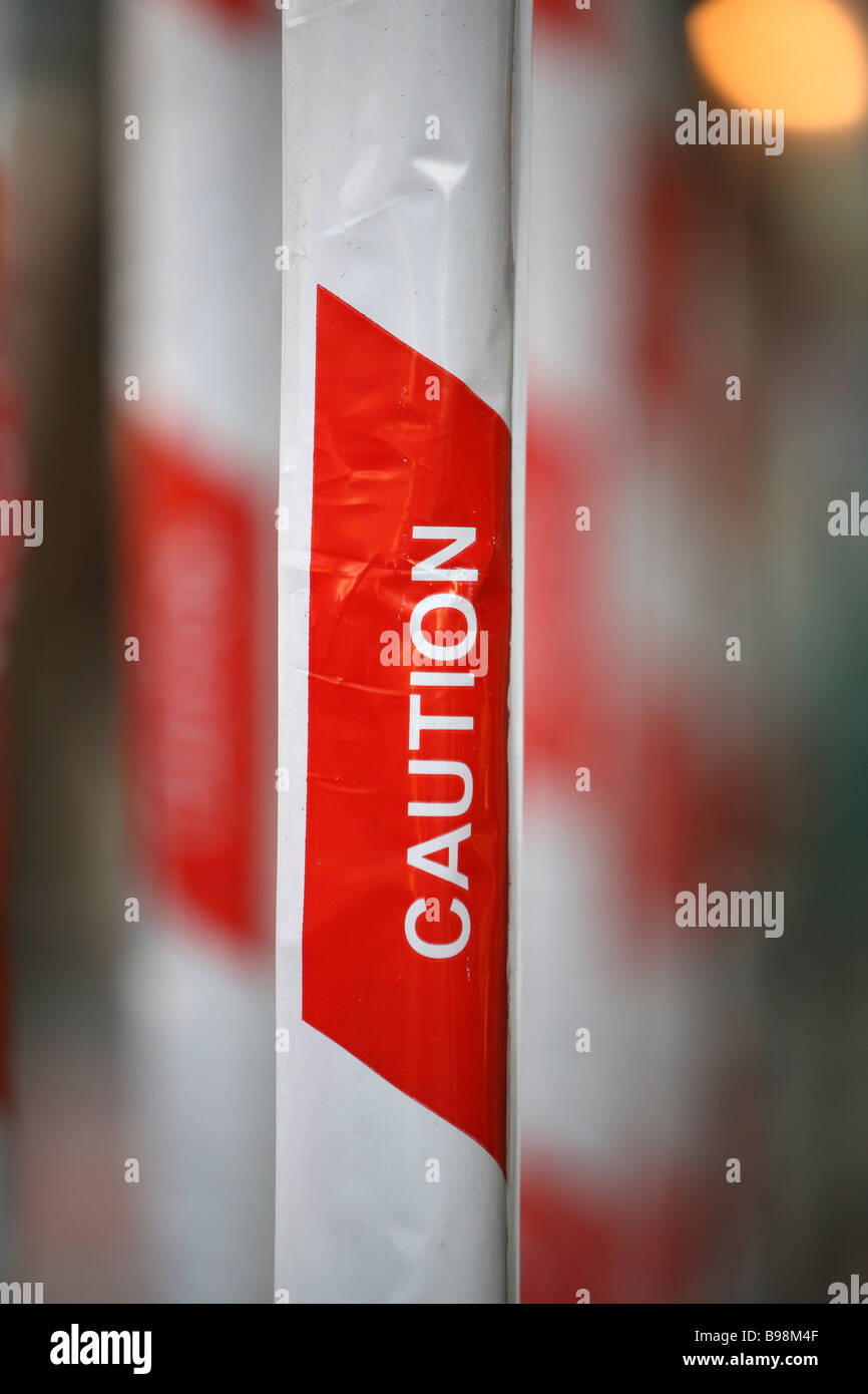 Plastic caution wrapping on scaffolding poles Stock Photo - Alamy