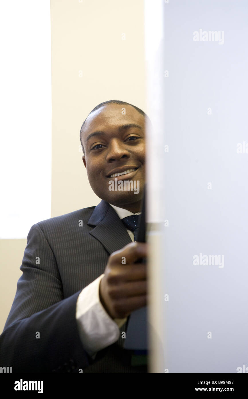 Businessman behind computer monitor Stock Photo - Alamy