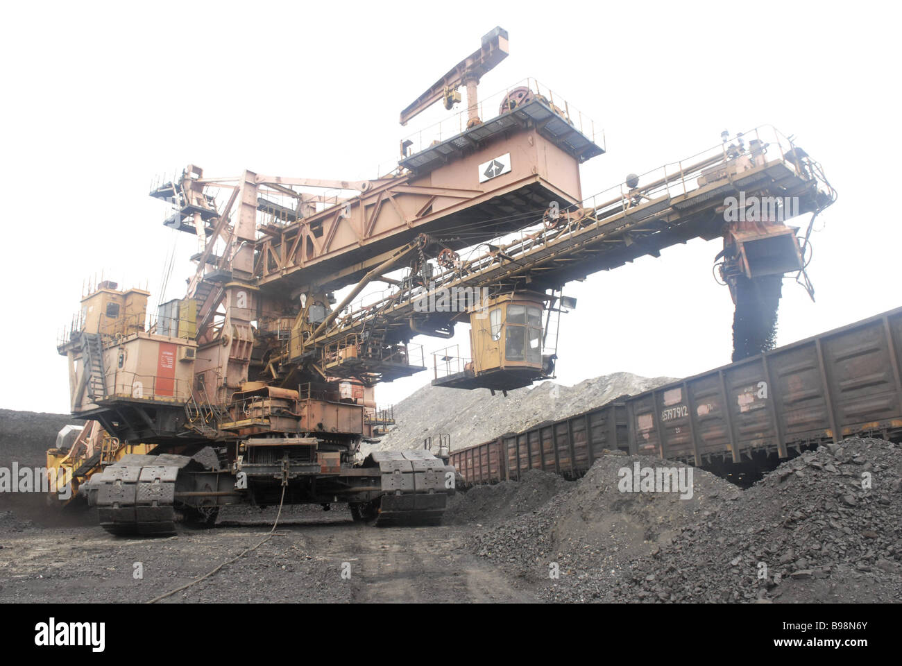 A rotary bucket excavator loading produced coal at the Mugunsky coal ...