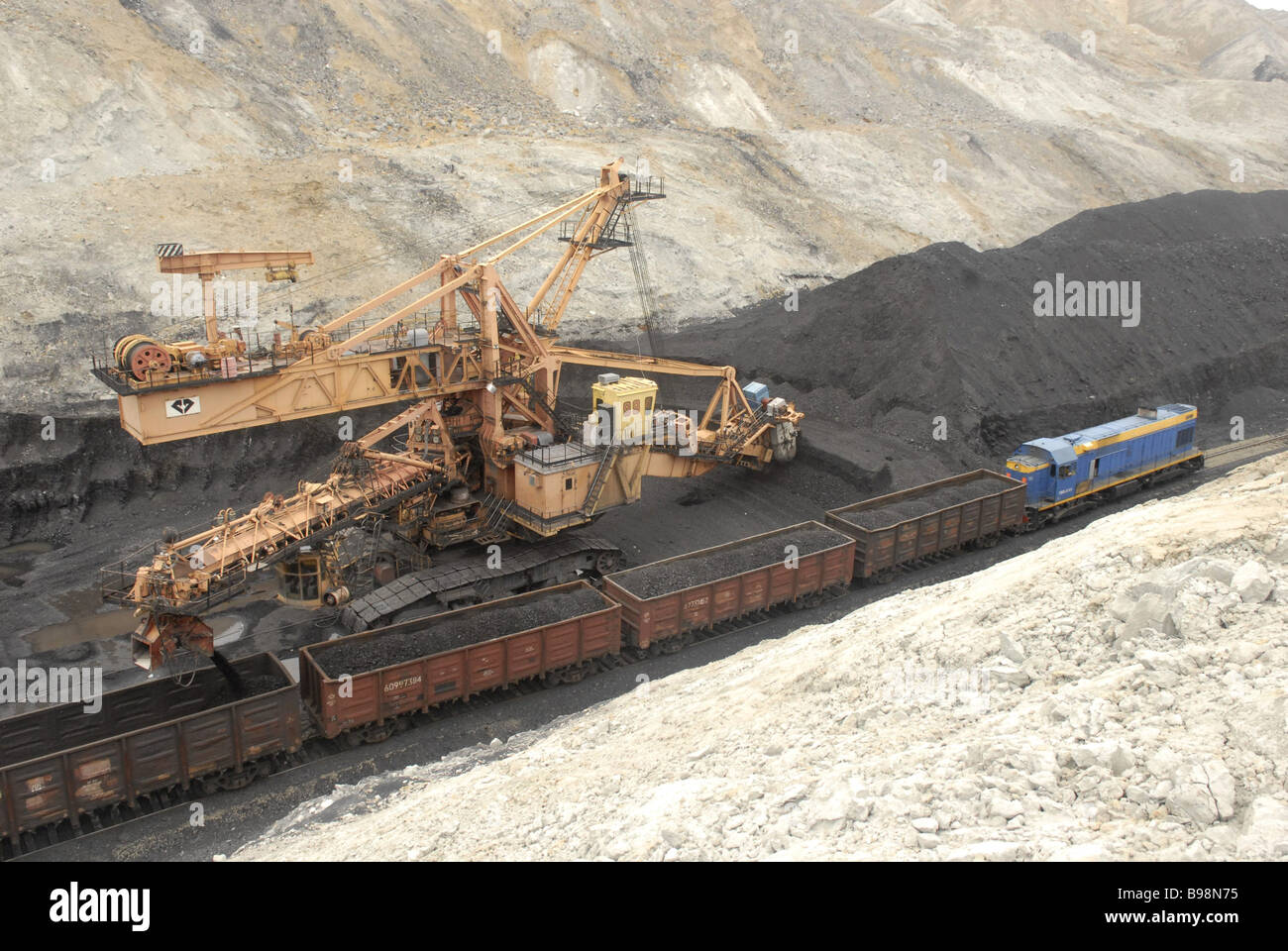 A rotary bucket excavator loading produced coal at the Mugunsky coal ...