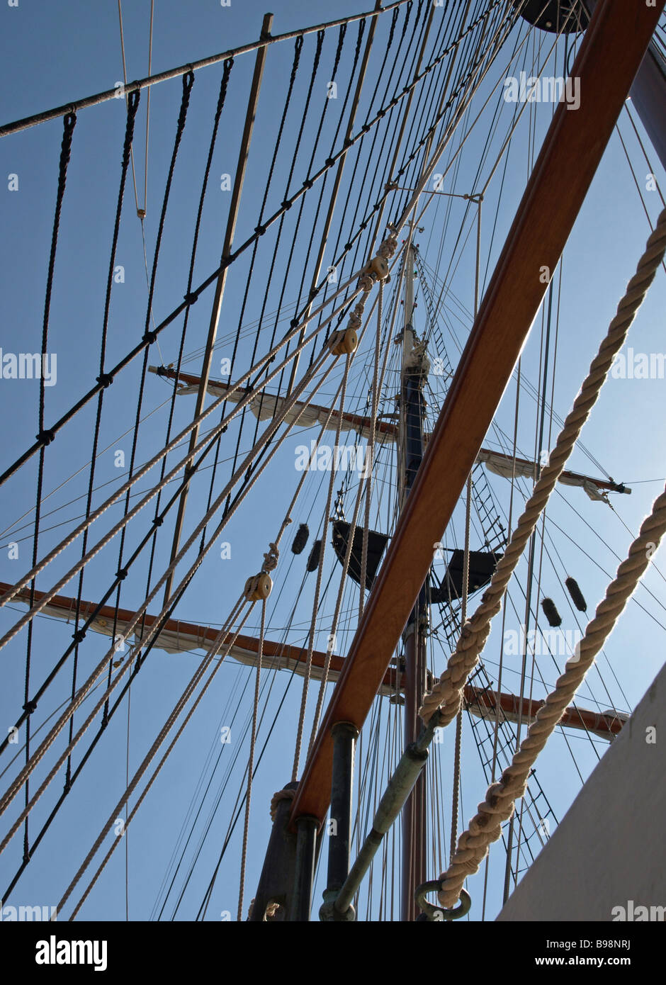 skyward view through the rigging of a three masted sailing vessel tall ...