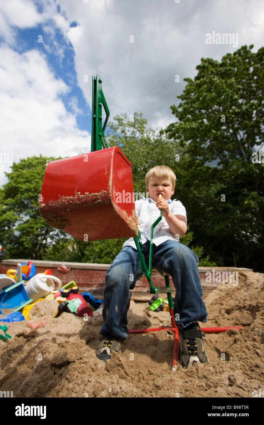 Boy playing in the sandbox Stock Photo - Alamy