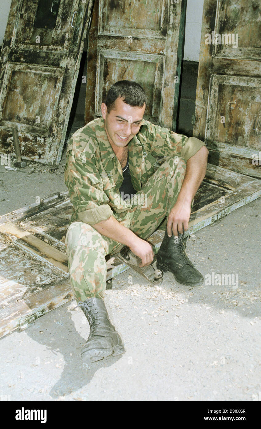 Active serviceman repairs the barracks door at the Arazap frontier post ...