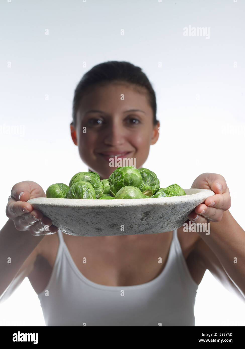 Young Women holding fresh vegetables Stock Photo - Alamy