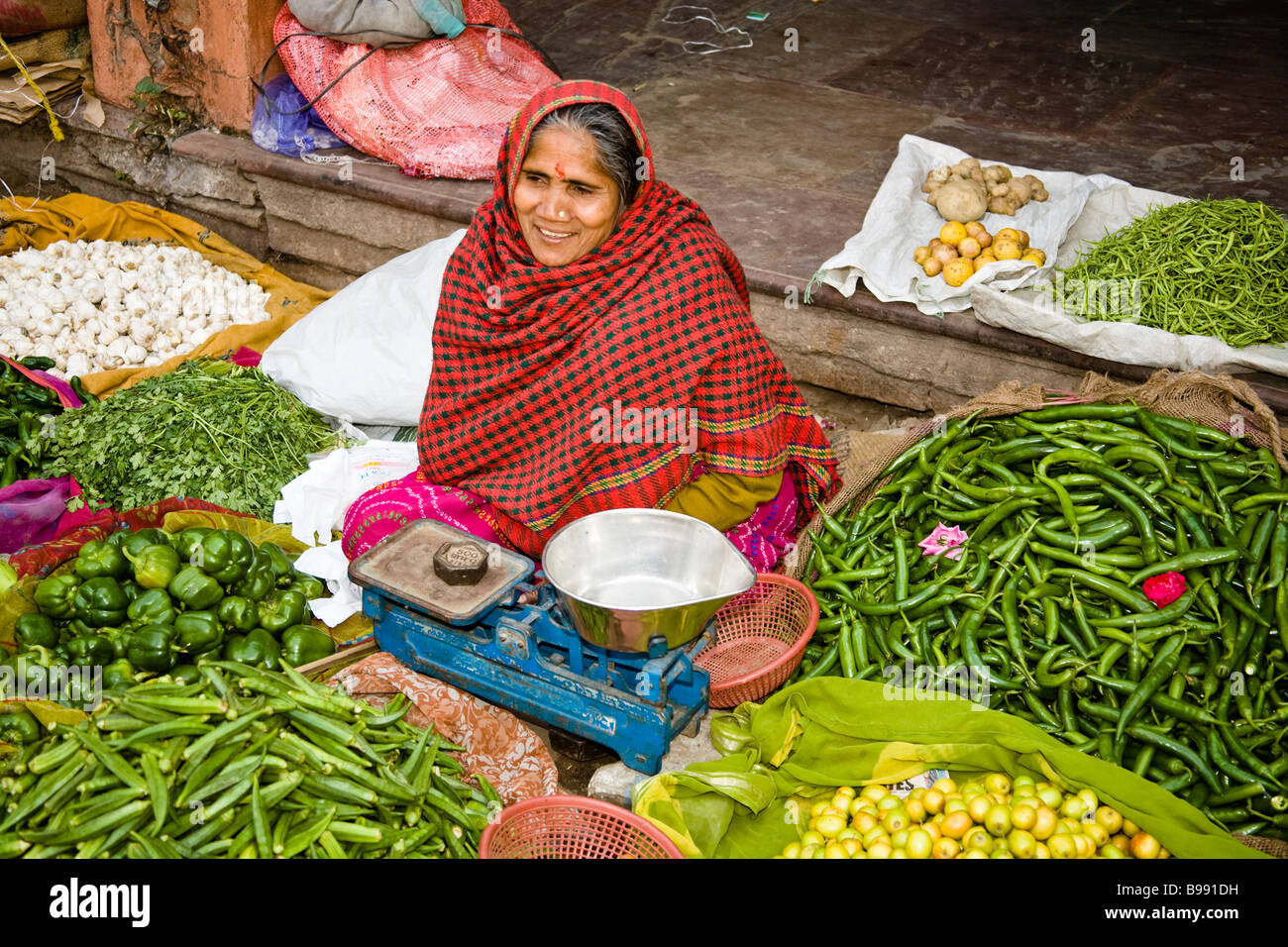 Woman selling vegetables in a street market, Chandpole Bazaar, Pink City, Jaipur, Rajasthan ...