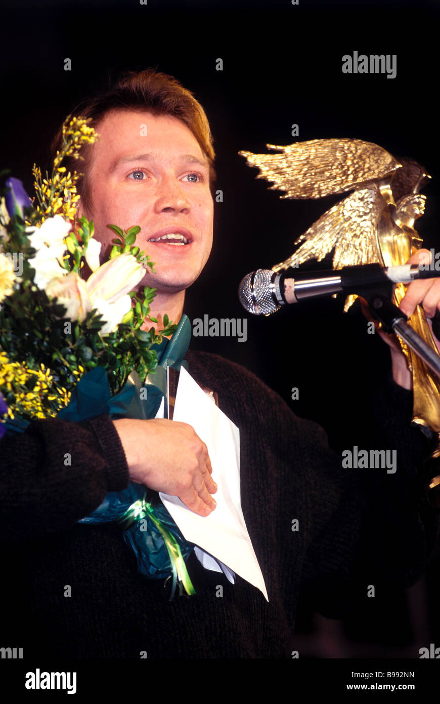 Actor Yevgeny Mironov holding the 1994 Nika prize of the ...