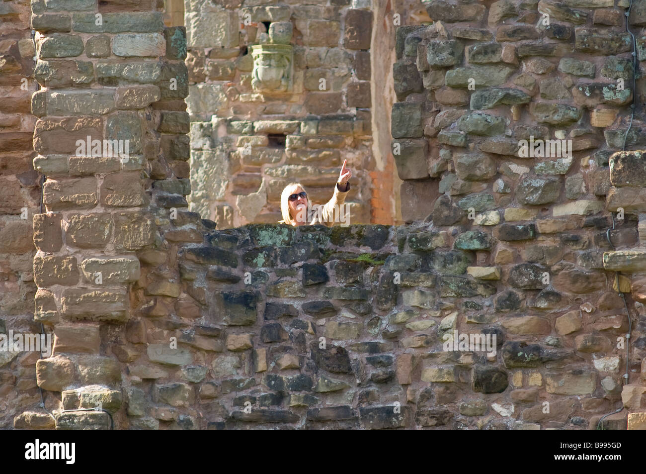 Young women pointing to the stone-work in a ruined building Stock Photo ...