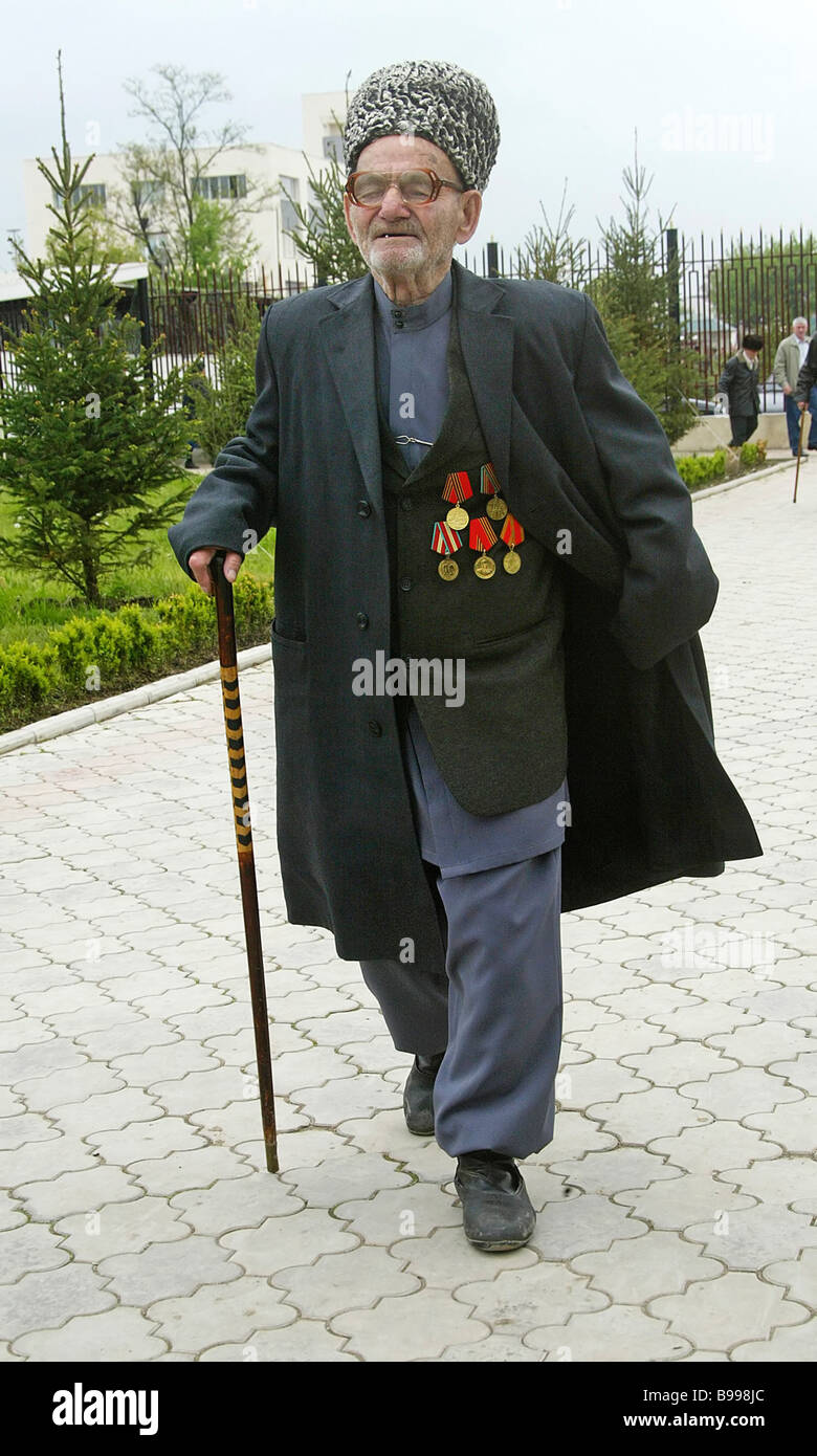 A bemedalled old man in a folk fur hat goes to a gala in honor of World ...