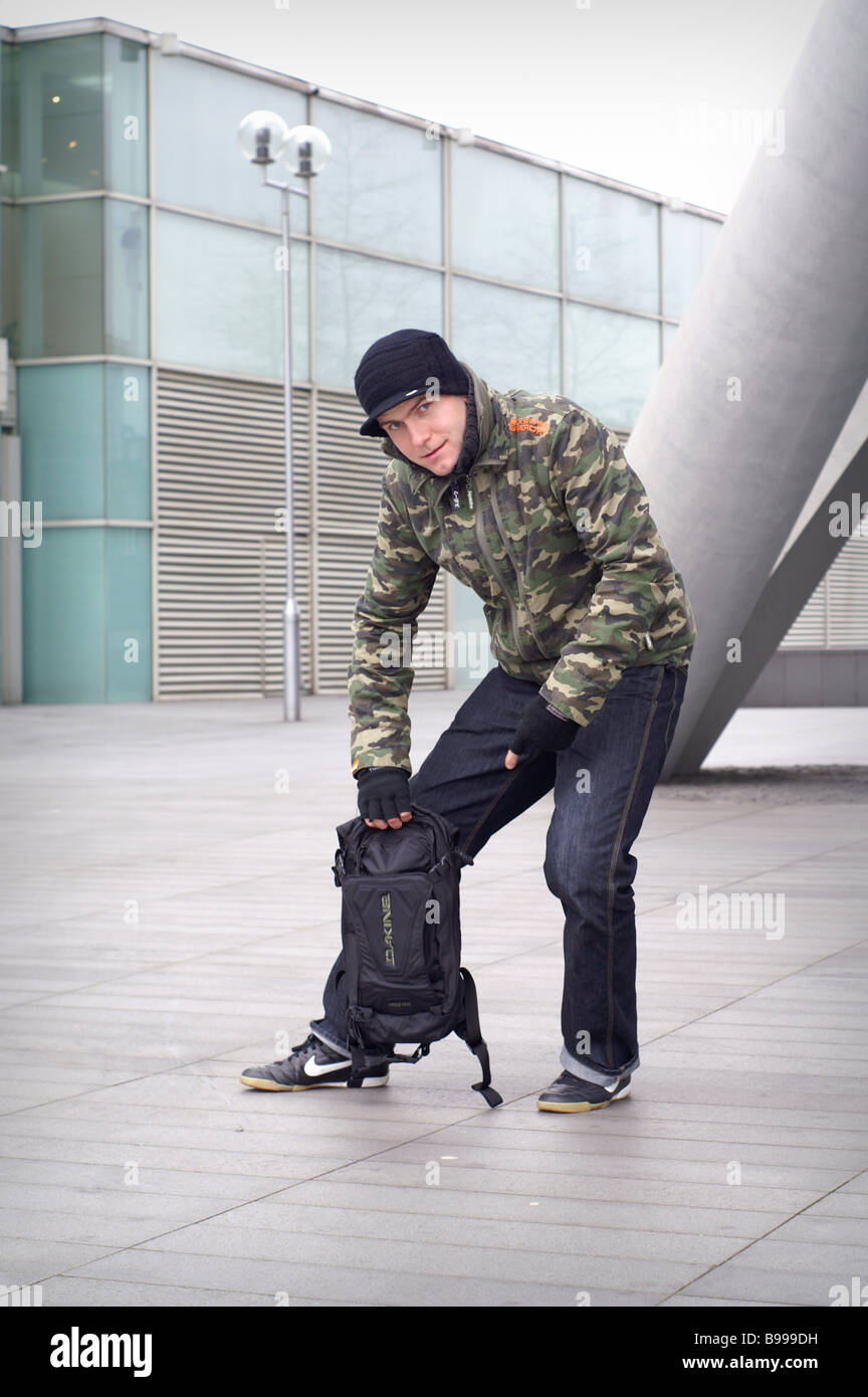 Man showing his backpack Stock Photo - Alamy