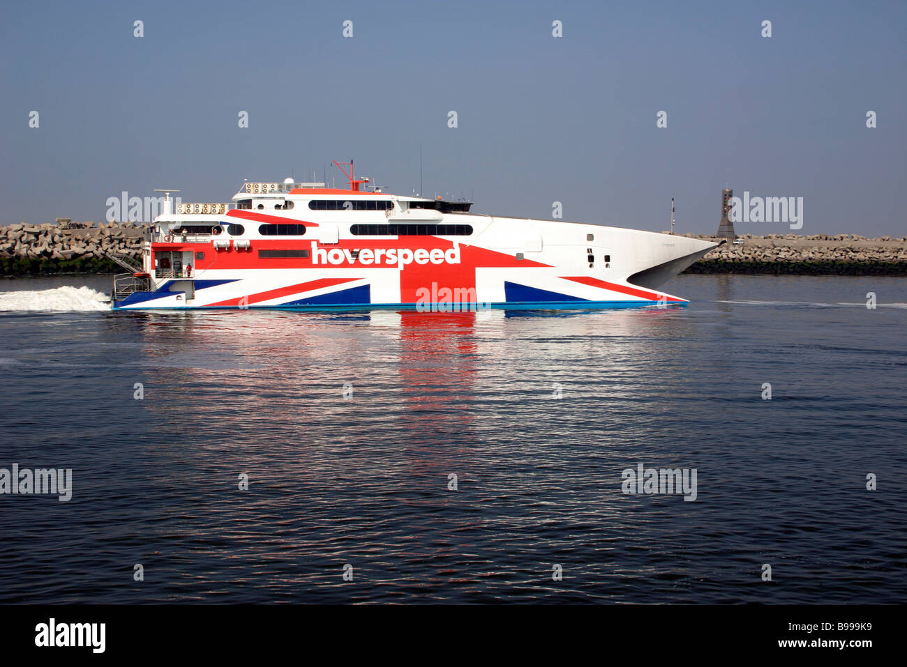 Hoverspeed hydrofoil passenger ferry boat entering harbour Union Jack ...
