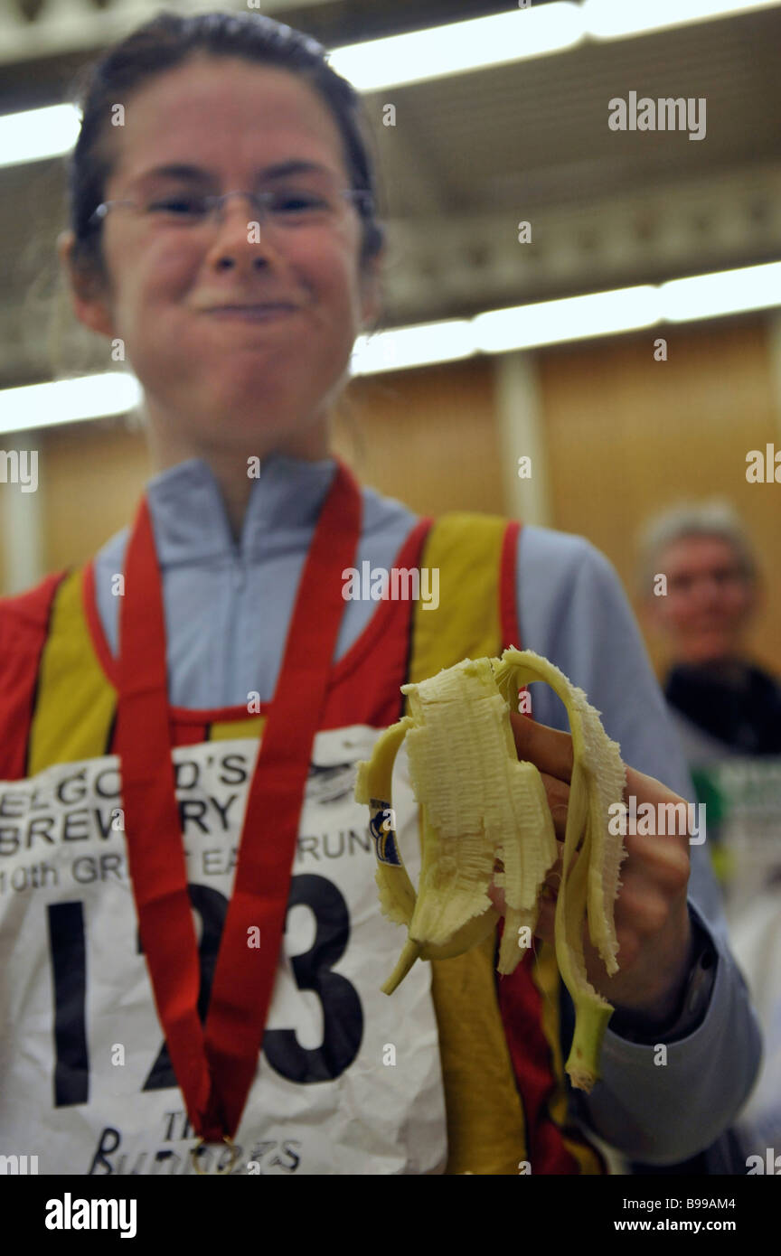 club girl eating banana after finishing running race Stock Photo - Alamy