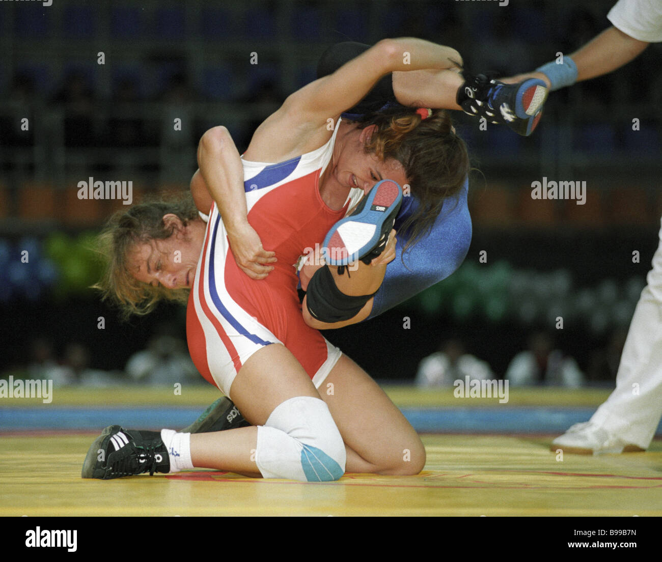 French woman wrestler Sophie Rlukvet doing a throw and American Brenda ...