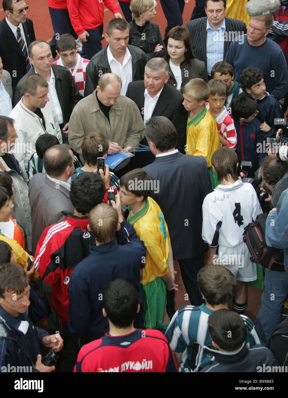Crowding for President Vladimir Putin s autographs as he visits the ...