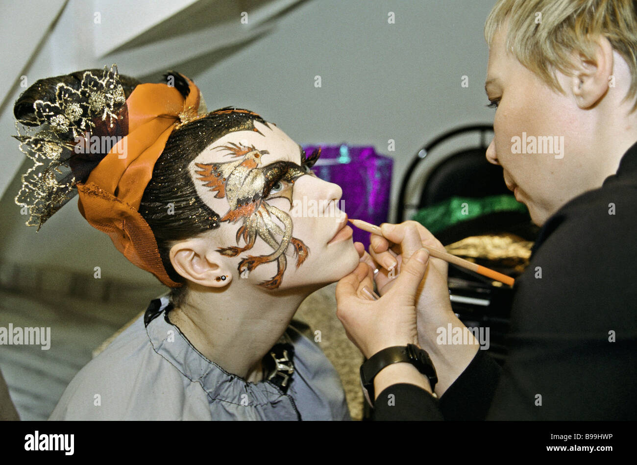 Applying make up to model s face during Fifth hairdressers festival ...