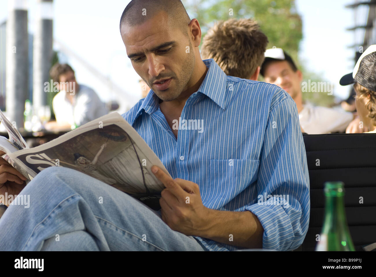 Man reading newspaper outdoors Stock Photo - Alamy